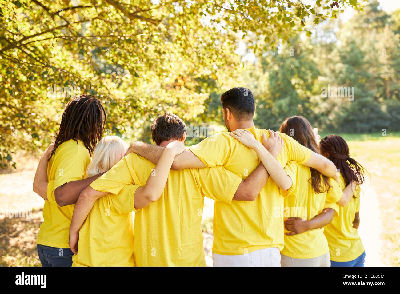 Young people hug each other in nature as a startup team for community ...
