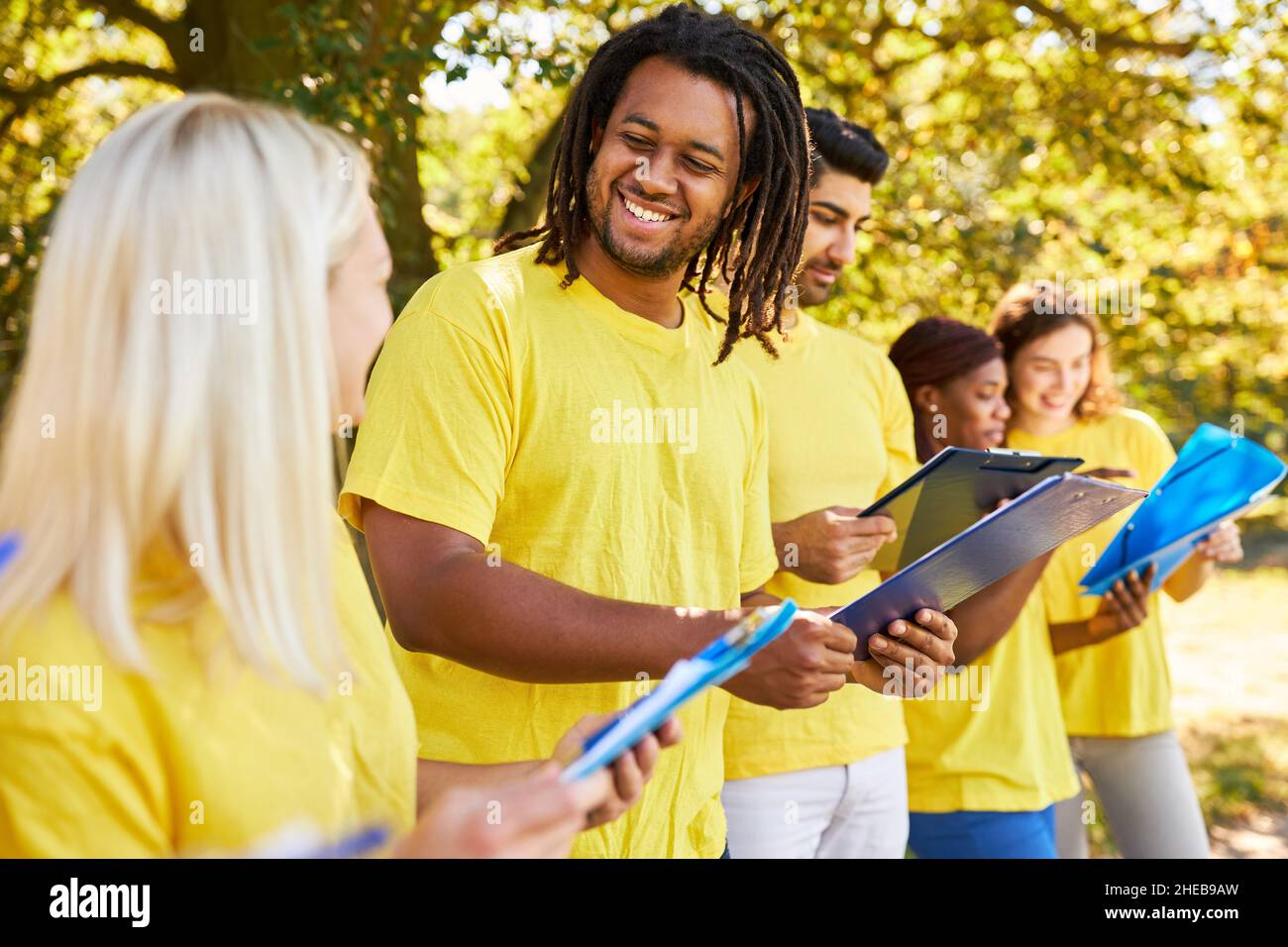 Multicultural team with clipboard during a cross-country game in the ...