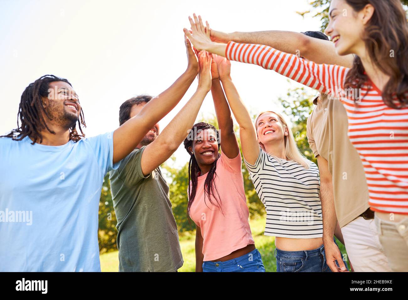 Group of multicultural friends at the high five for motivation and team ...