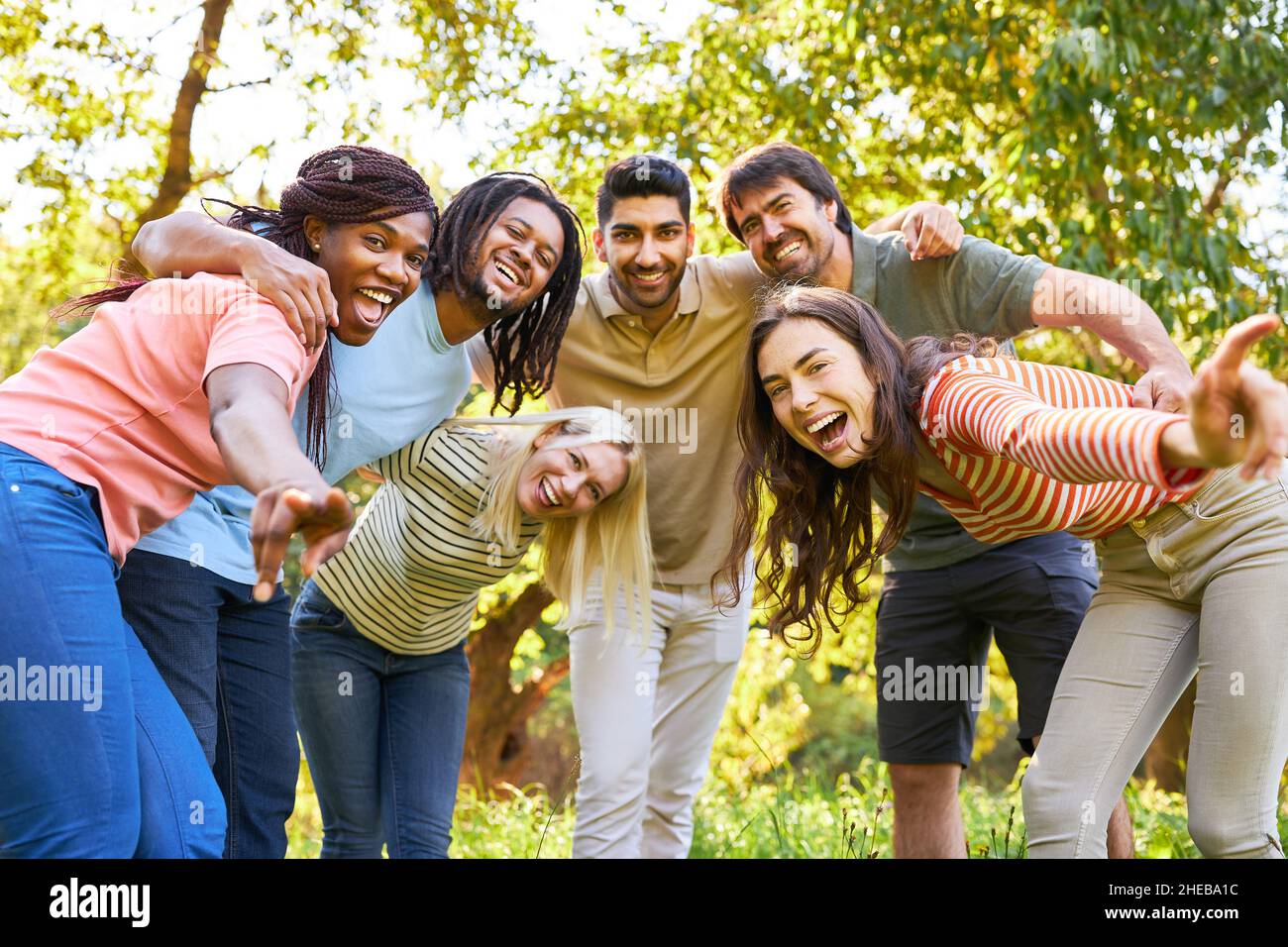 Young multicultural start-up team as a diverse community in the summer ...