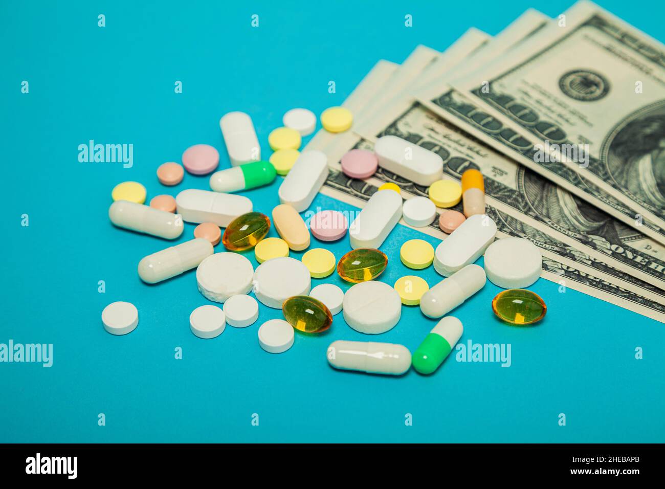 Money pills. Medicine pills on dollar bills on a blue background Covid ...
