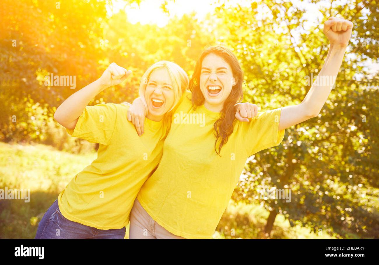 Happy women in team cheer together with clenched fists in nature Stock ...