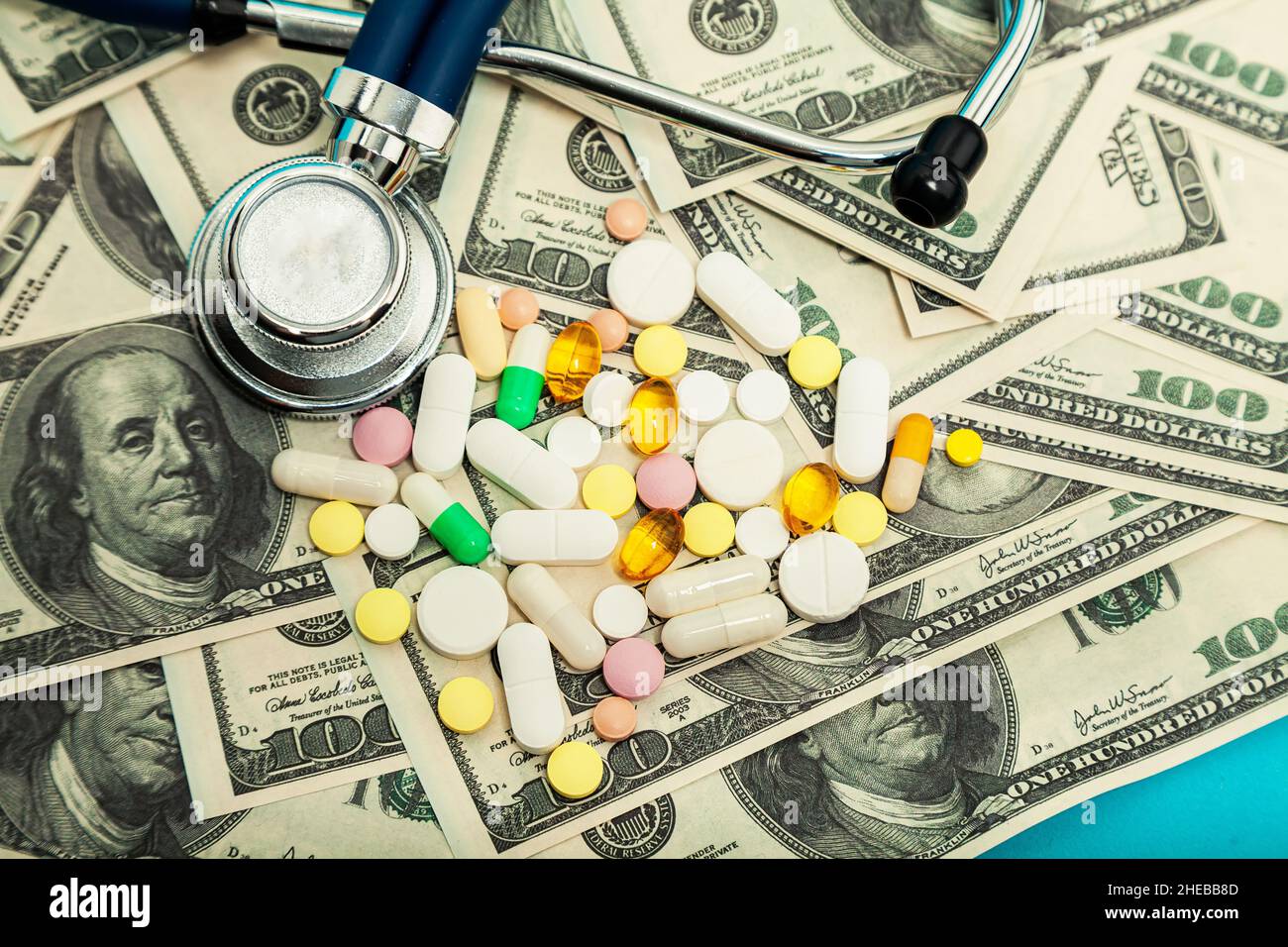 Money pills. Medicine pills on dollar bills on a blue background Covid ...