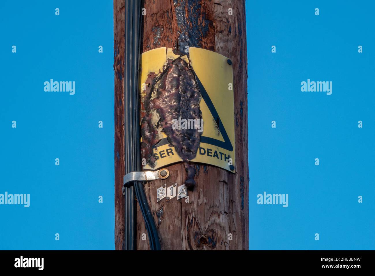 Warning sign on electricity pole hi-res stock photography and images ...