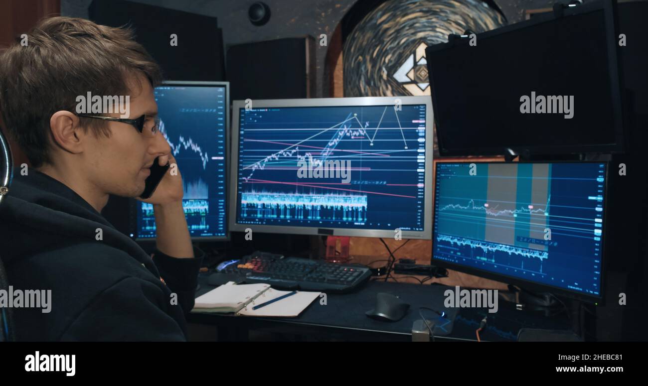 Male trader, a freelancer discusses stock exchange quotation charts on ...