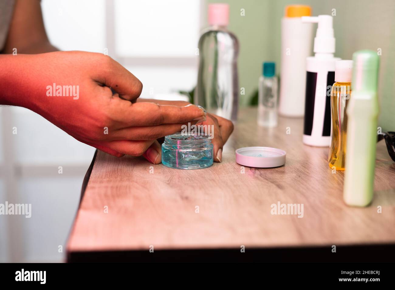 Focus on bottle, close up shot of taking cold or moisturizing cream for ...