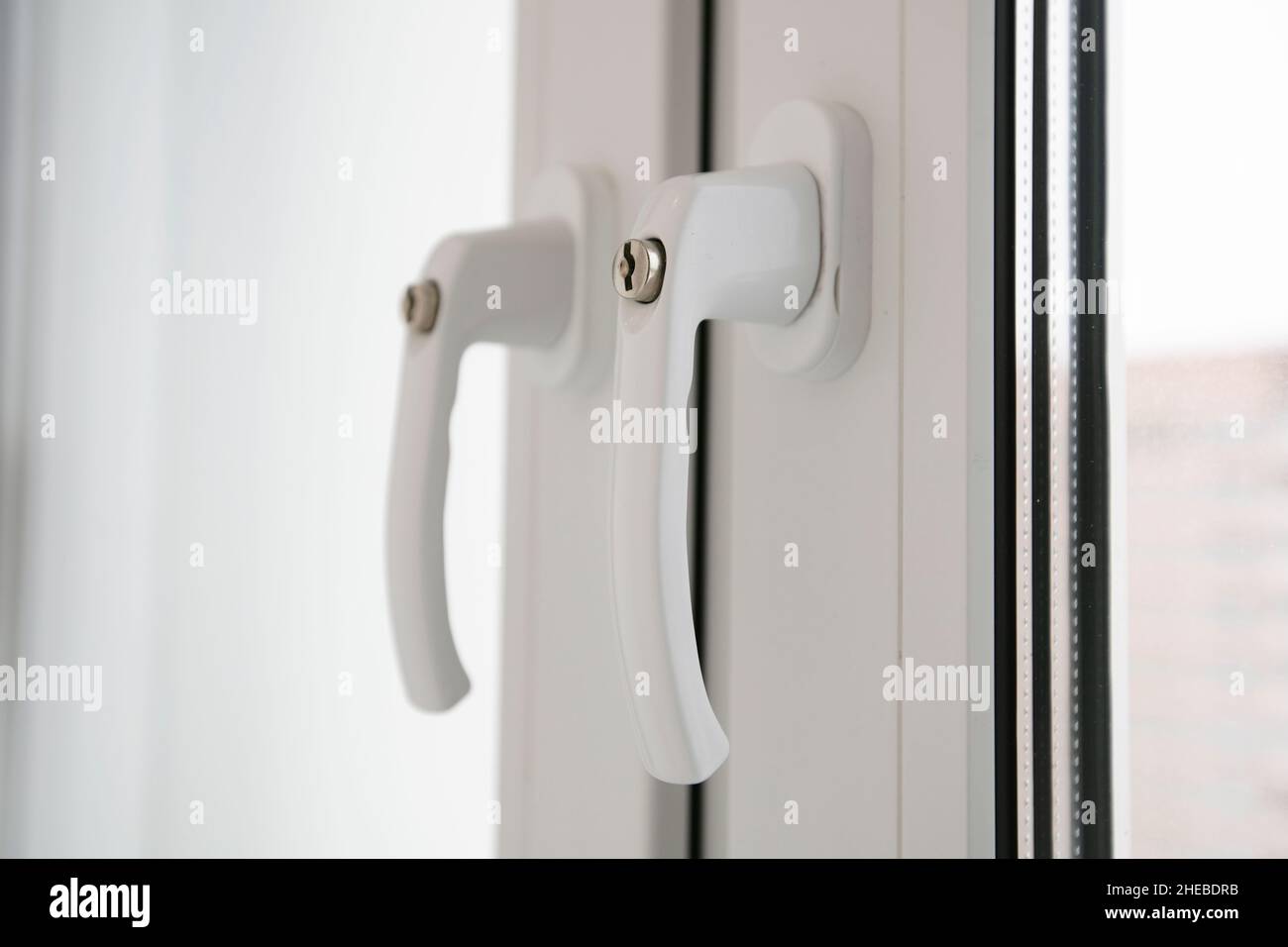 White plastic window handle. Open the window Stock Photo - Alamy