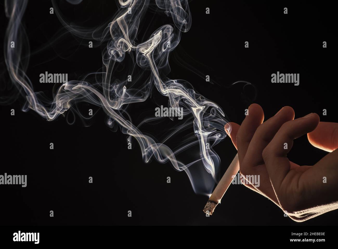 Tobacco is wacko. Steaming cigarette in male hand. Smoking habit ...