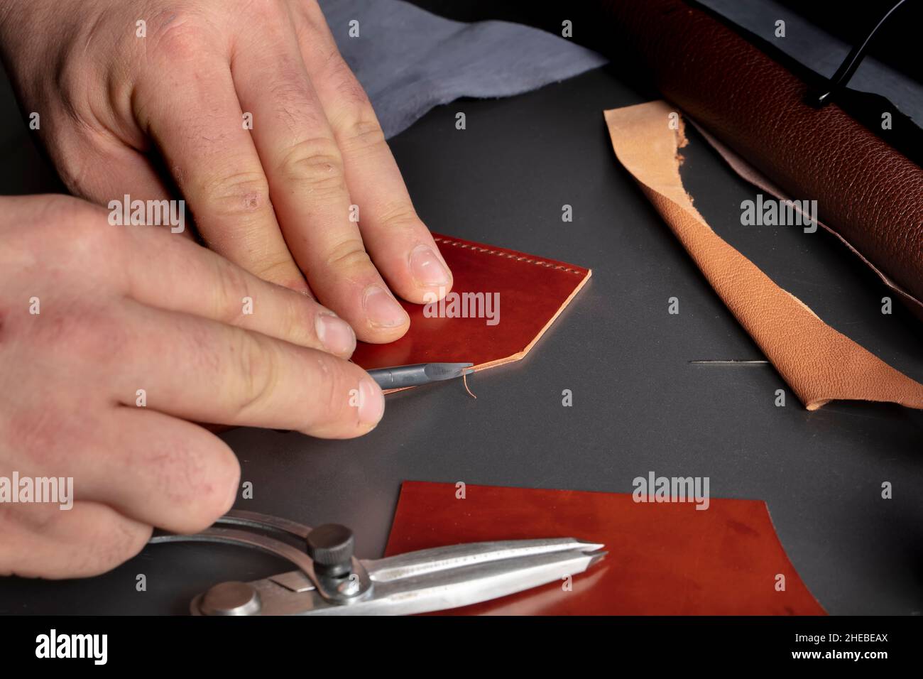 The process of making leather goods. The hands of the master work with ...