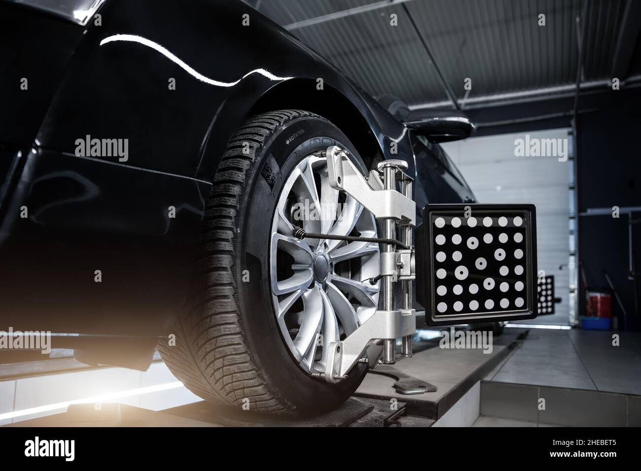 CLose-up car wheel indoors service maintenance repair center against ...
