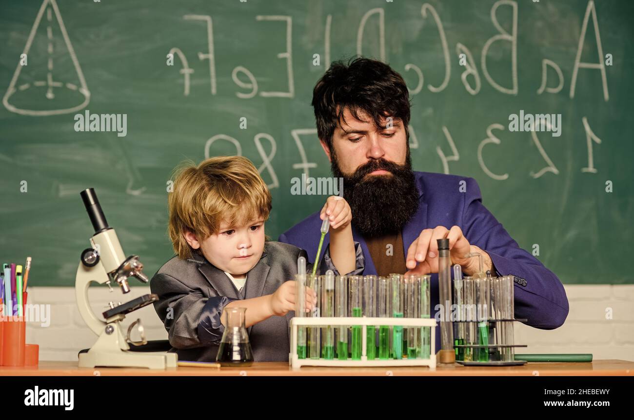 learning chemistry in school laboratory. Back to school. teacher man ...