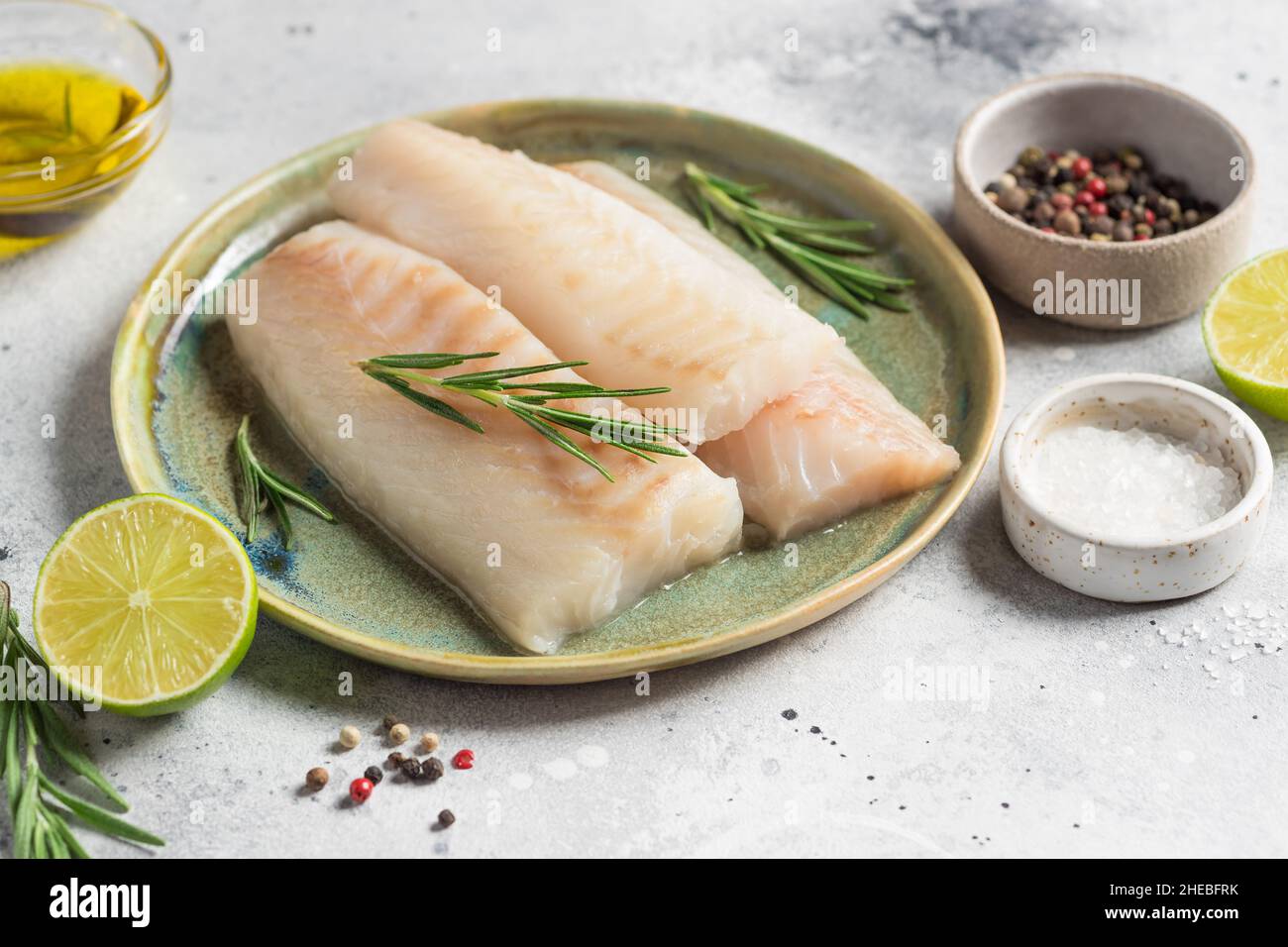 raw cod fillets with rosemary, spices on kitchen table Stock Photo - Alamy