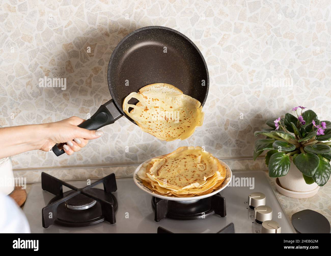 woman cooking pancakes in kitchen. Vegetarian breakfast Stock Photo - Alamy