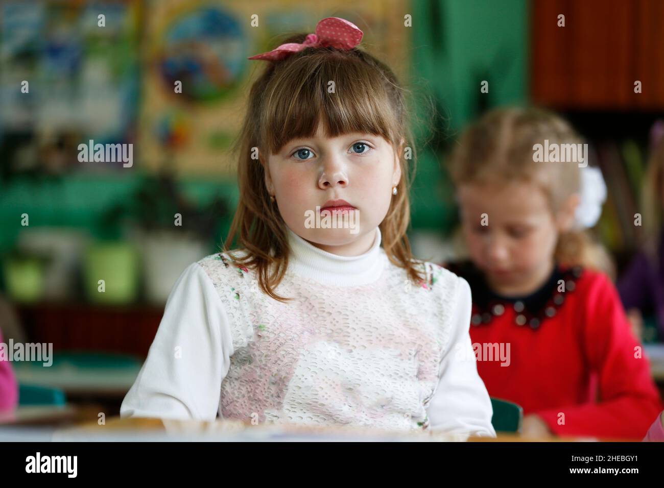 . A preschool girl or primary school student looks at the camera Stock ...