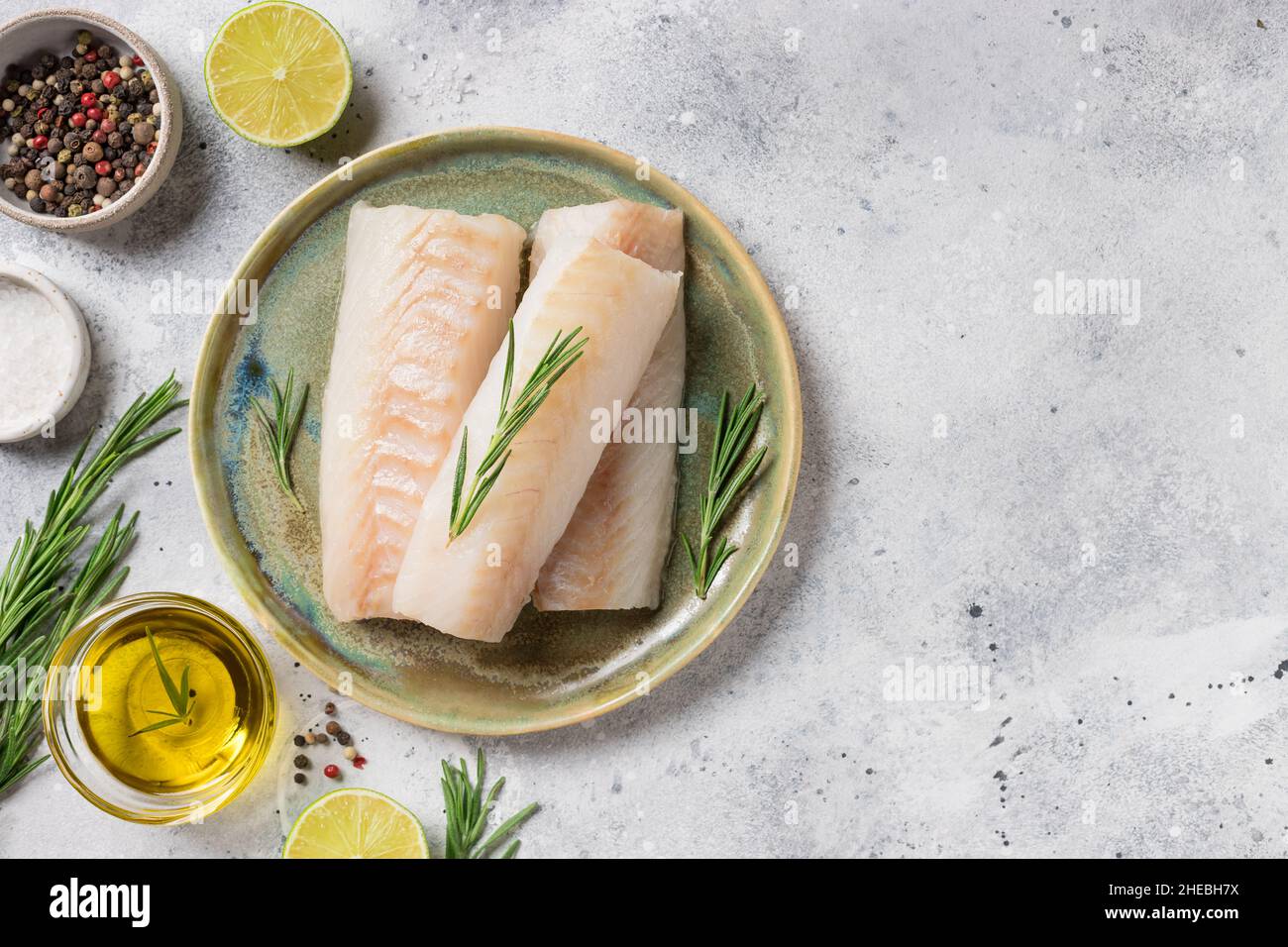 Raw cod loin fillet steak with aromatic herbs, spices, oil Stock Photo ...