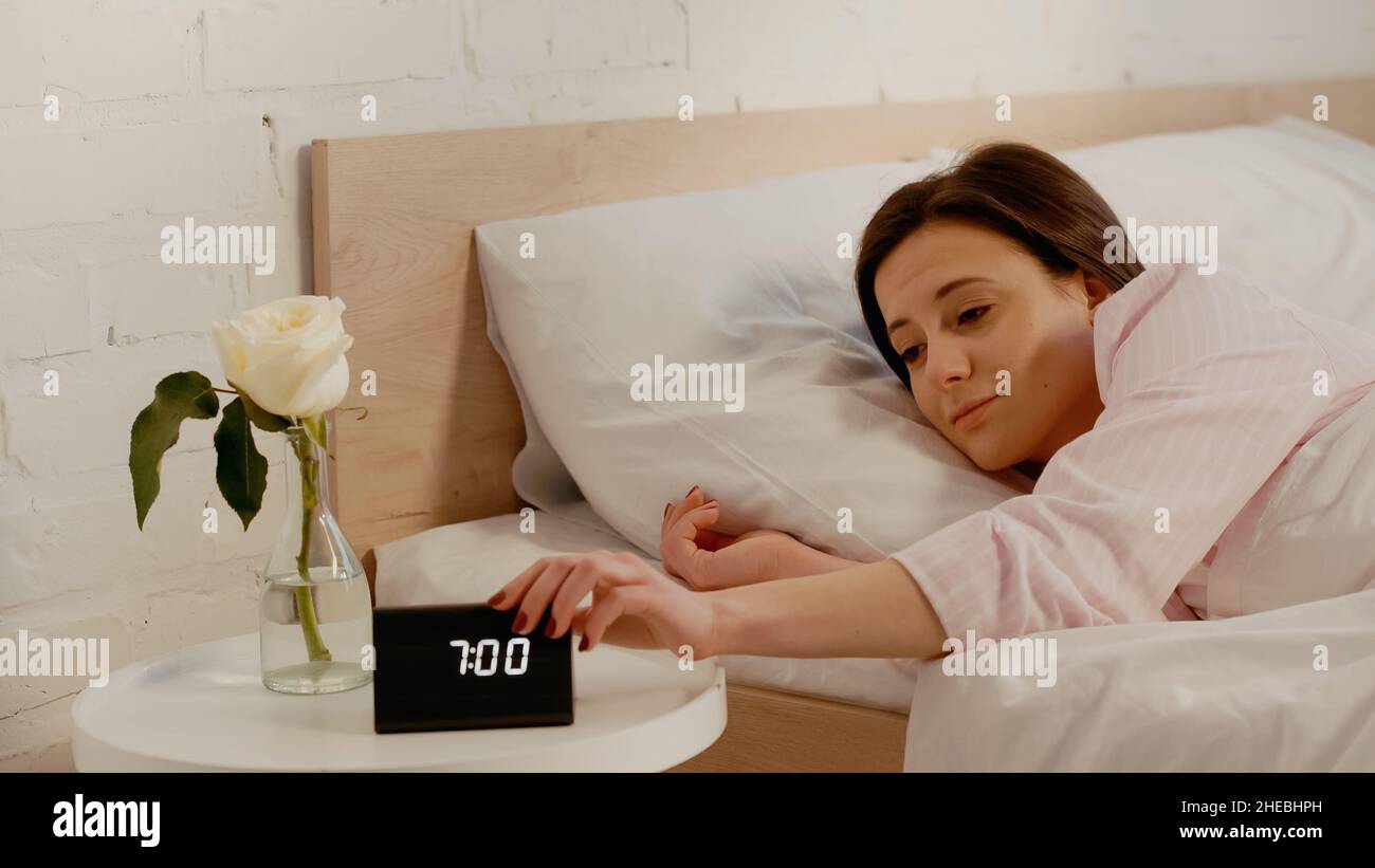 Woman turn off alarm clock bed hi-res stock photography and images - Alamy