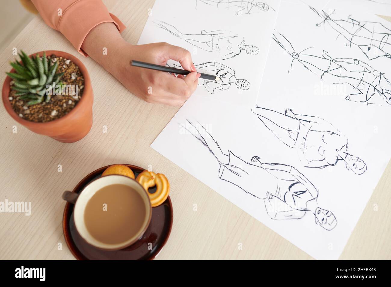 Hands of tailor drawing fashion sketches of new collection Stock Photo ...