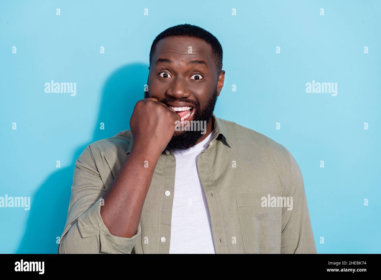 Photo of young african man bite fists trouble fail scared reaction ...