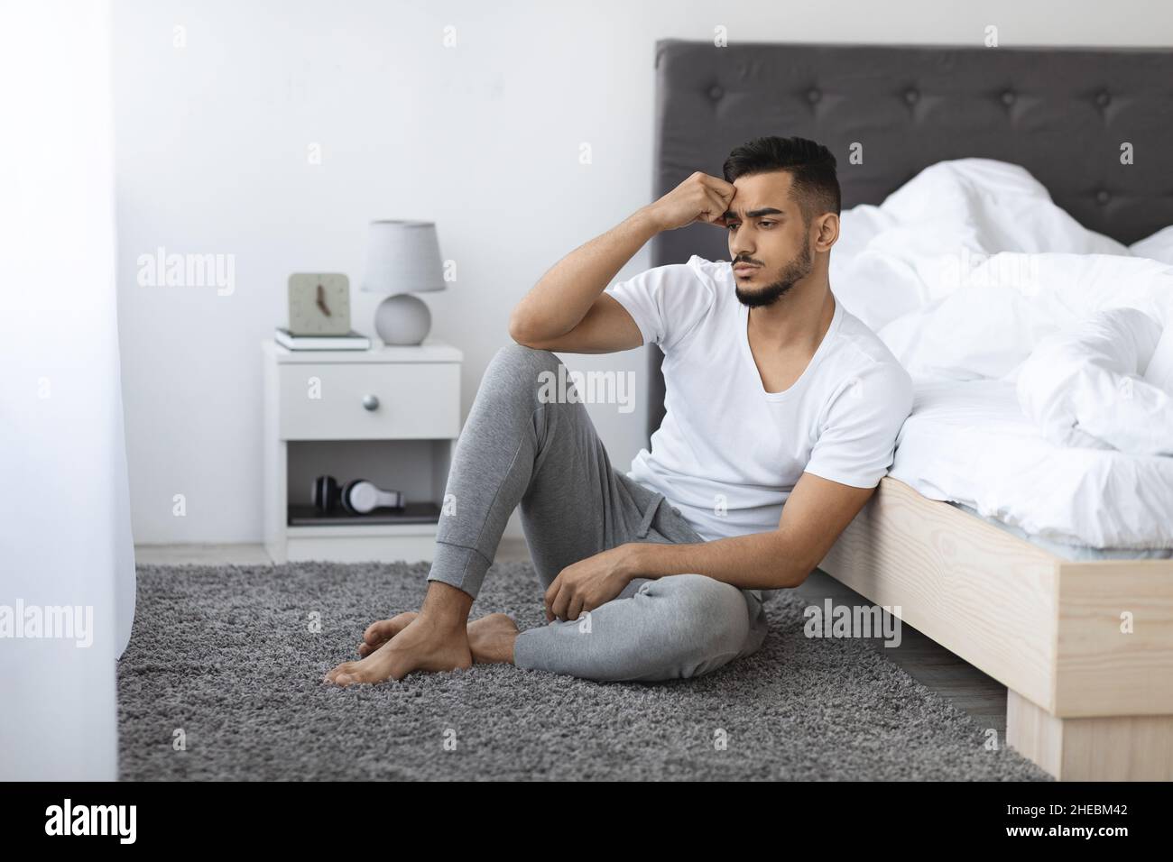 Melancholy Concept. Thoughtful Upset Arab Man Sitting On Floor In ...