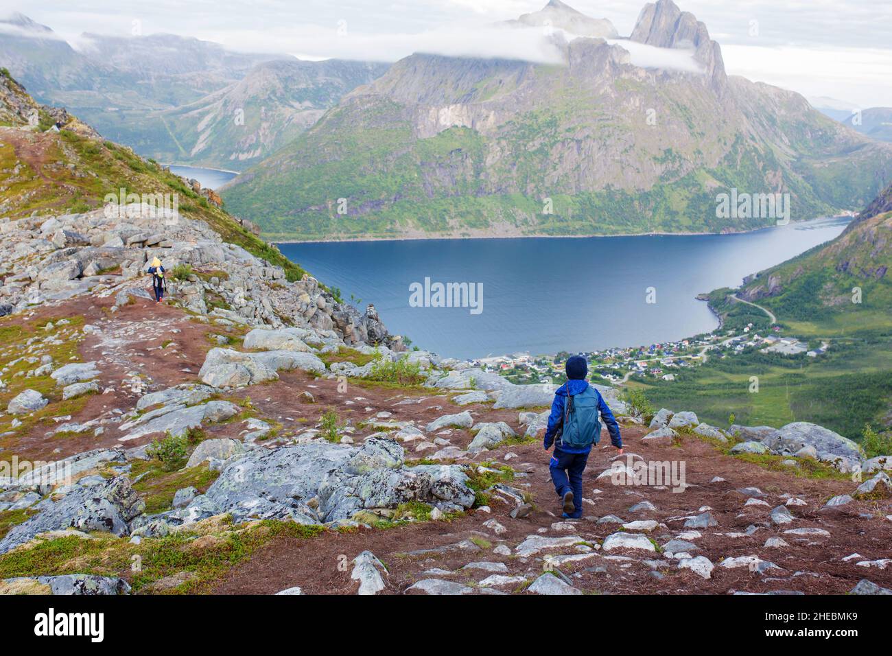 Happy family, standing on a rock and looking over Segla mountain on ...