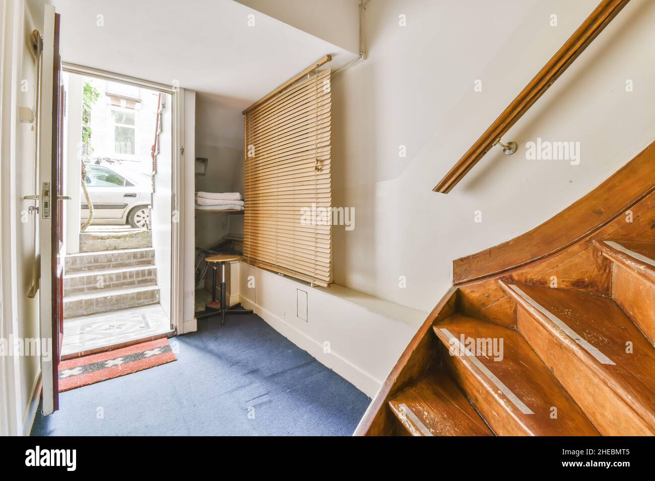 Amazing house entrance with open door near wooden staircase Stock Photo ...