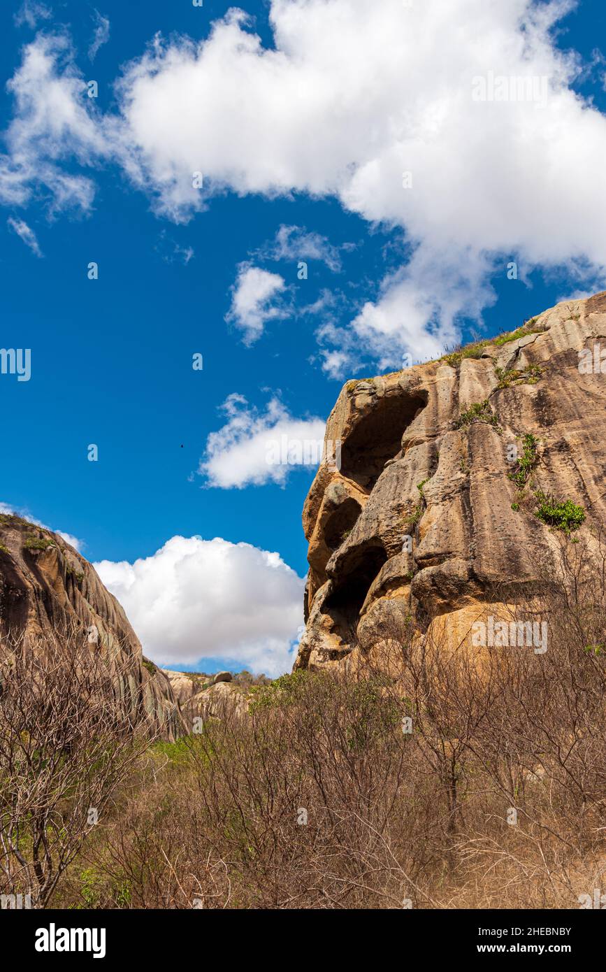 Natural caves carved in a mountain peak resembling a human face Stock ...