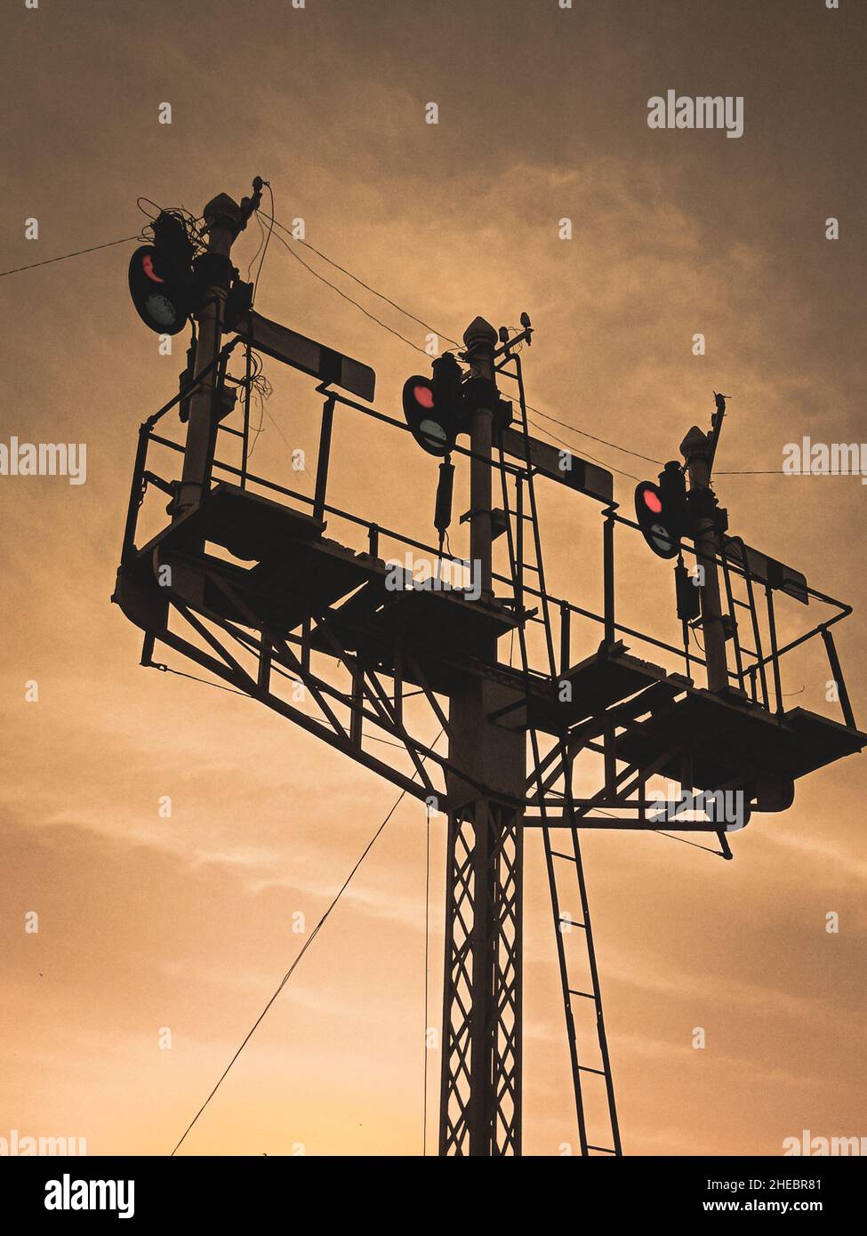 Train track signal at sunset Stock Photo - Alamy