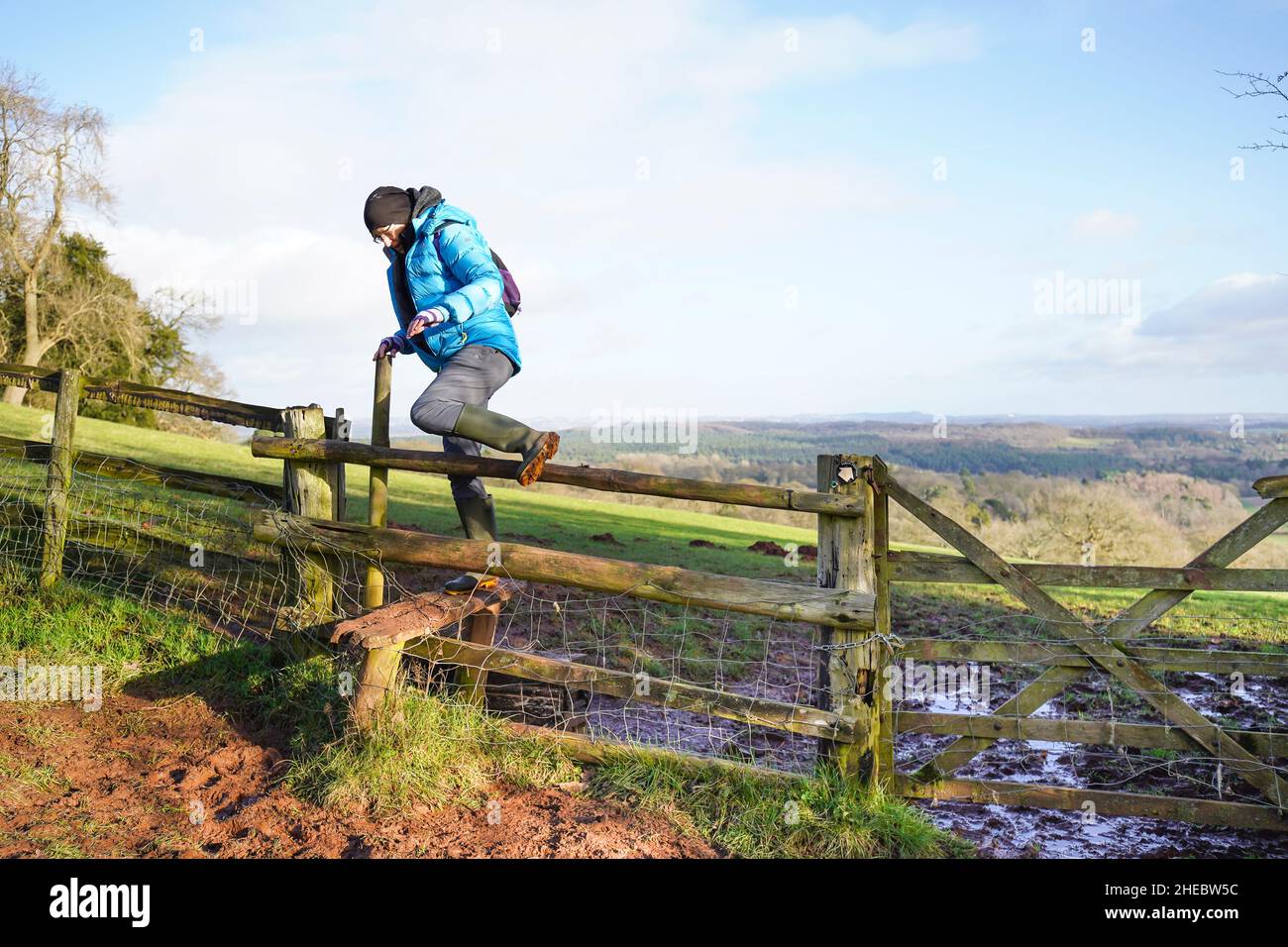 Woman climbing over gate hi-res stock photography and images - Alamy