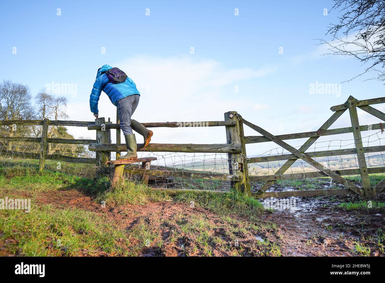 Woman climbing over gate hi-res stock photography and images - Alamy