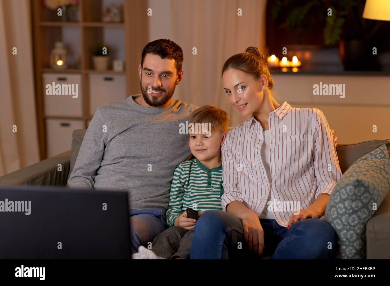 happy family watching tv at home at night Stock Photo - Alamy