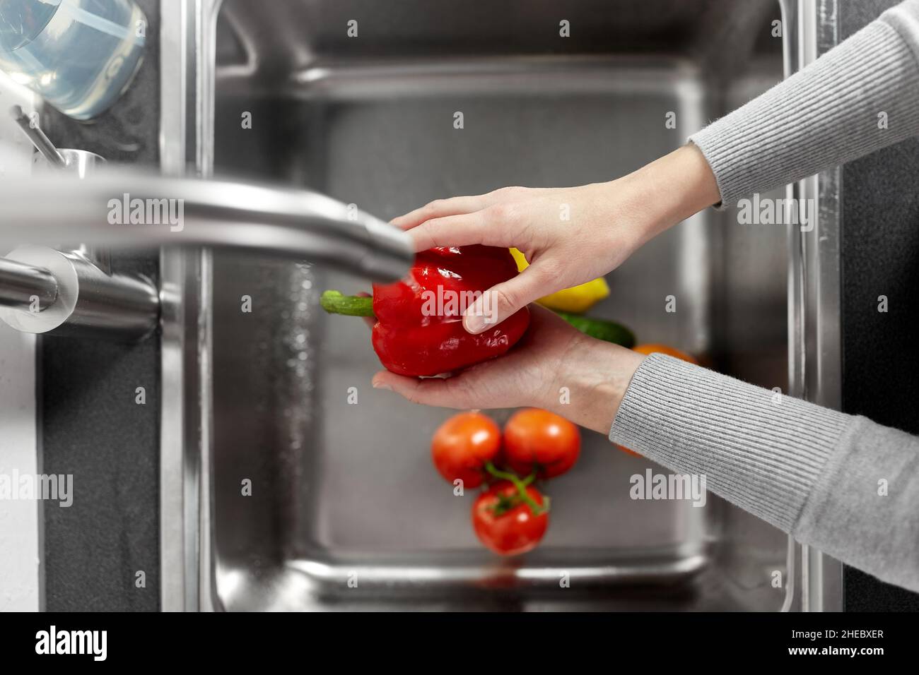 woman washing fruits and vegetables in kitchen Stock Photo - Alamy