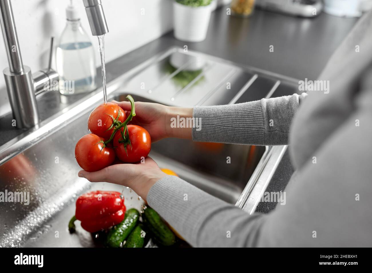 close up of woman washing vegetables in kitchen Stock Photo - Alamy