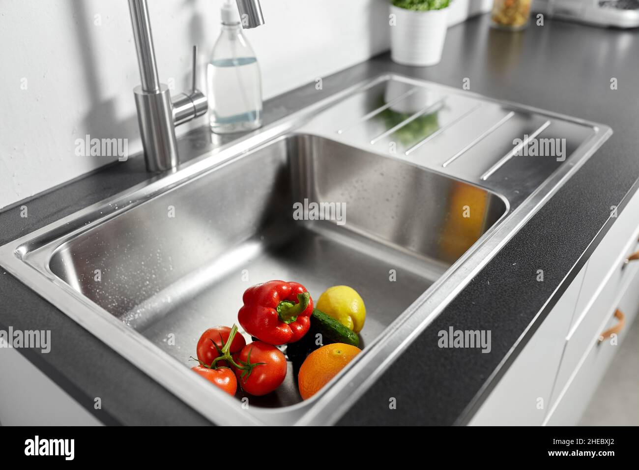 fruits and vegetables in kitchen sink Stock Photo - Alamy