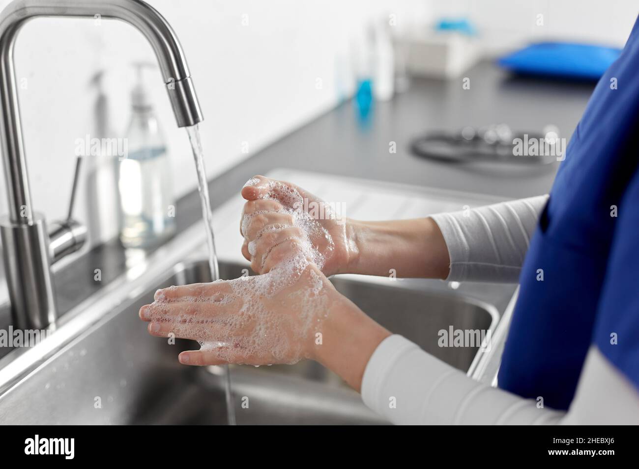 Nurse washing hands with tap hi-res stock photography and images - Alamy