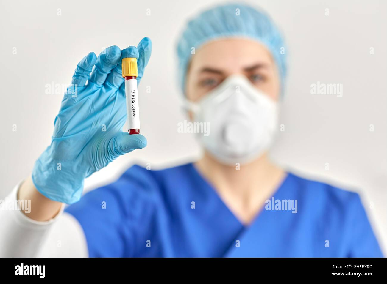 doctor holding beaker with virus blood test Stock Photo - Alamy