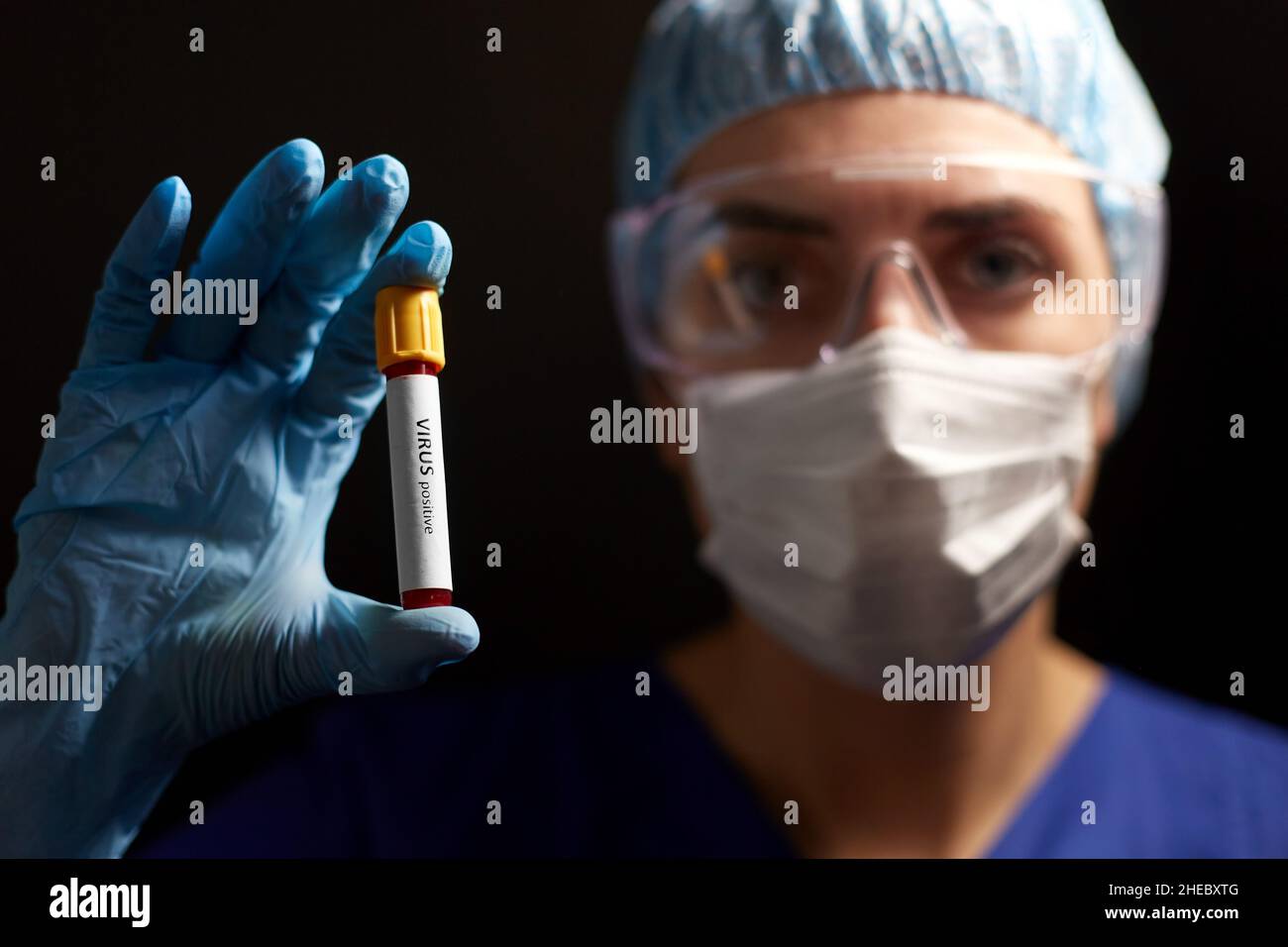 doctor holding beaker with virus blood test Stock Photo - Alamy