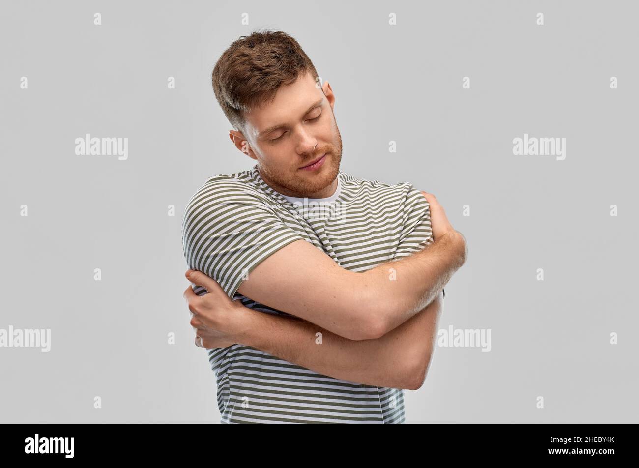 Man hugging himself hi-res stock photography and images - Alamy