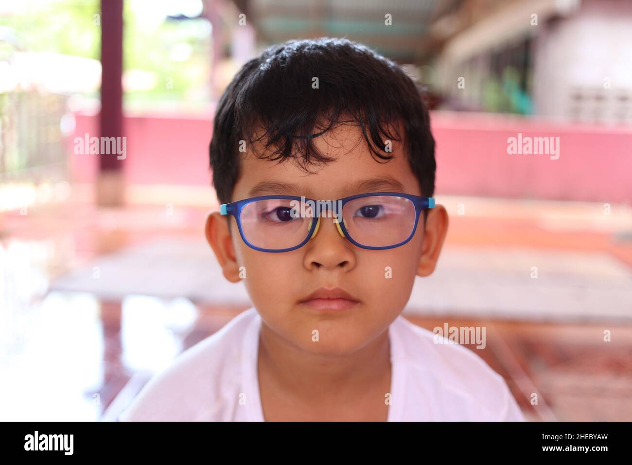 Straight face photo of asian boy with wearing glasses for design in ...