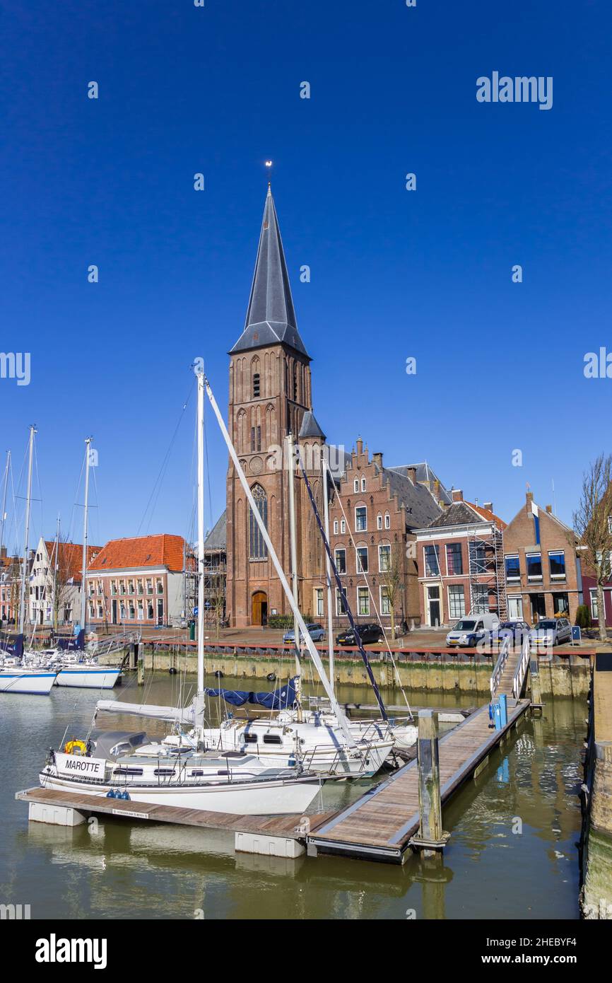 White sailing yacht in front of the catholic church in Harlingen ...