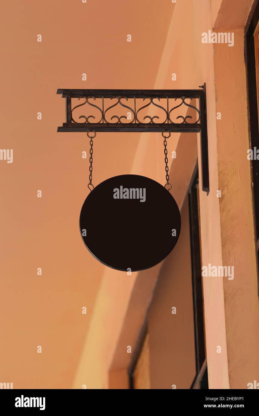 Empty black vintage sign hanging on the storefront Stock Photo - Alamy