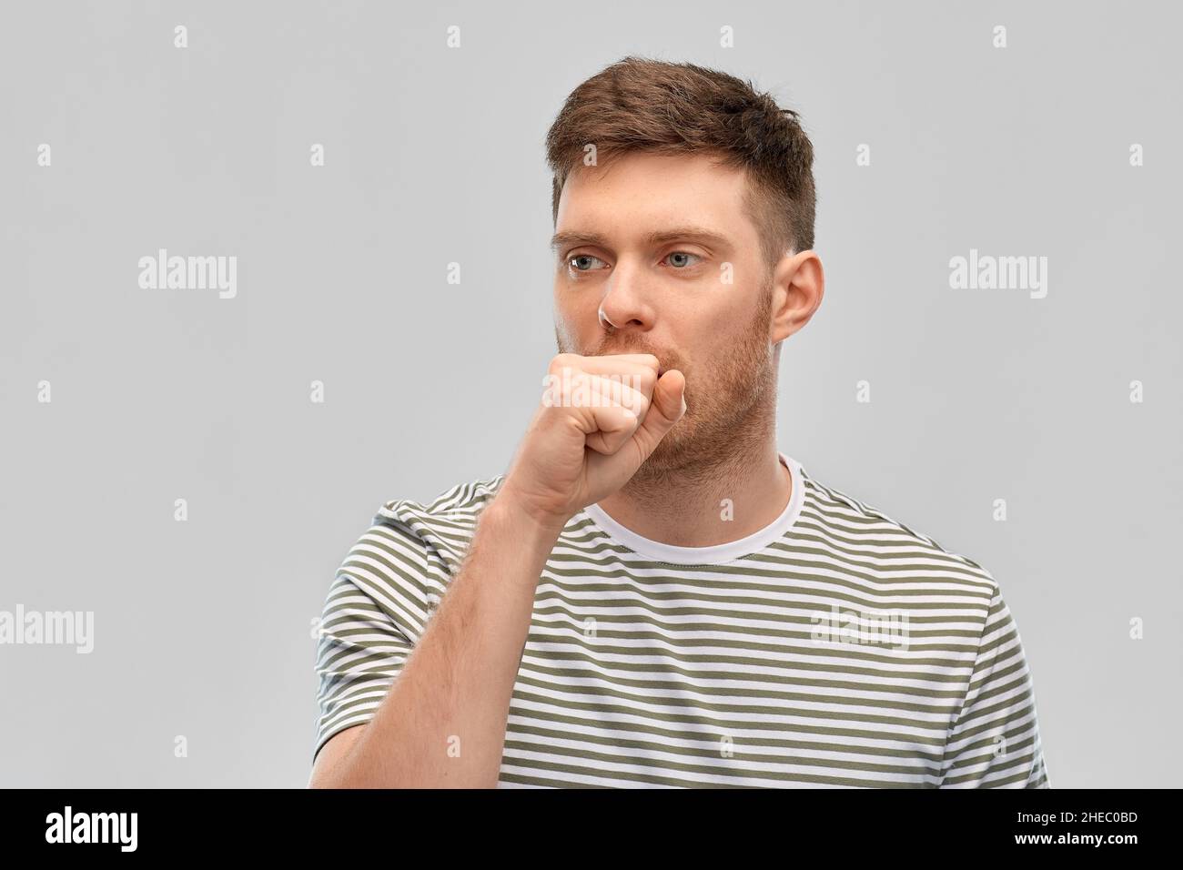 unhealthy young man coughing Stock Photo - Alamy
