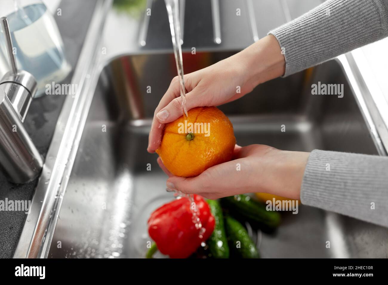 woman washing fruits and vegetables in kitchen Stock Photo - Alamy