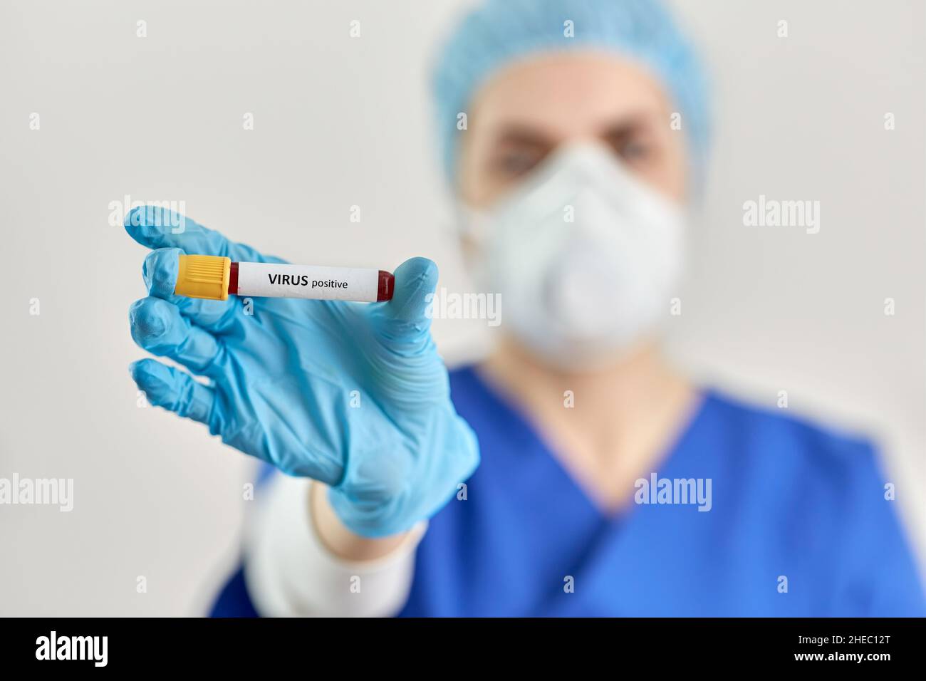doctor holding beaker with virus blood test Stock Photo - Alamy