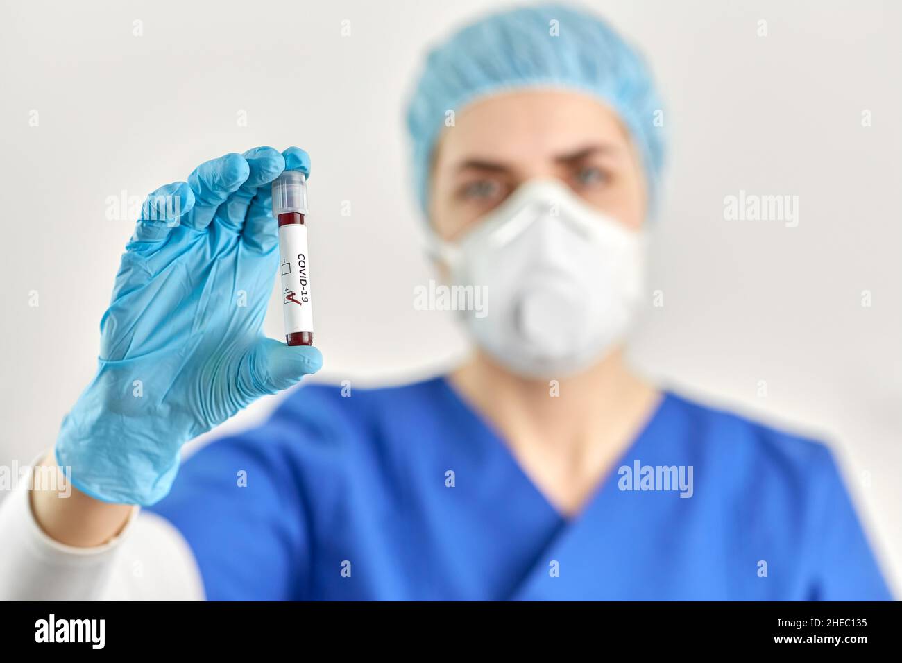 Doctor holding beaker coronavirus blood hi-res stock photography and ...