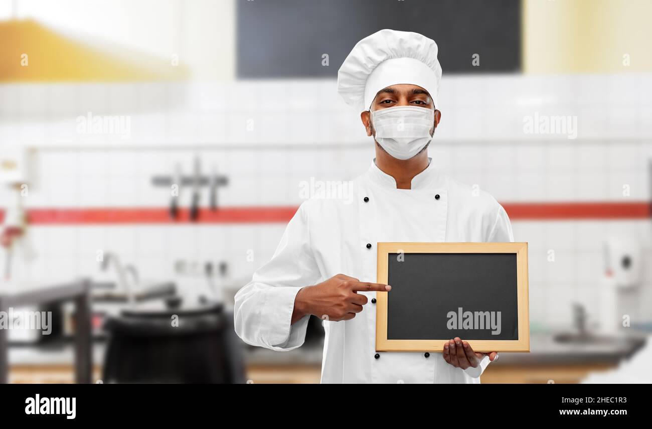 chef in face mask with chalkboard at kitchen Stock Photo - Alamy