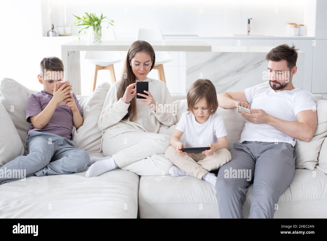 Family sitting together on sofa hi-res stock photography and images - Alamy