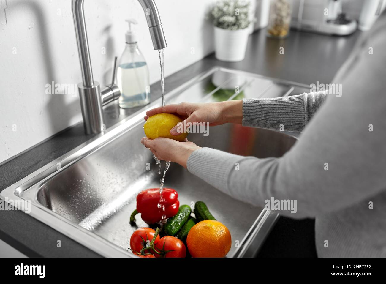 woman washing fruits and vegetables in kitchen Stock Photo - Alamy