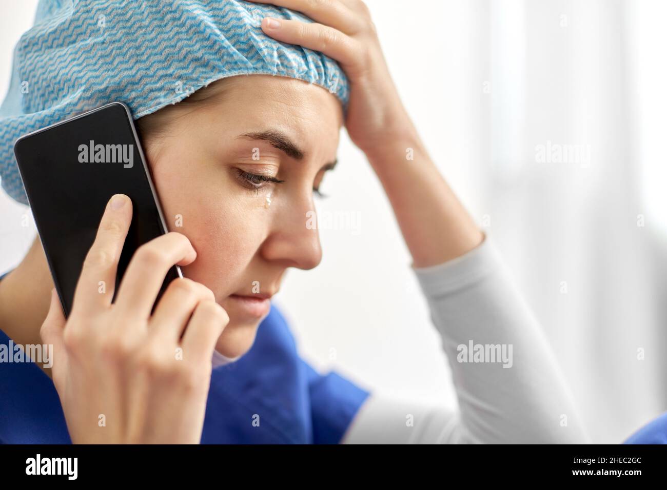sad doctor or nurse calling on smartphone Stock Photo - Alamy