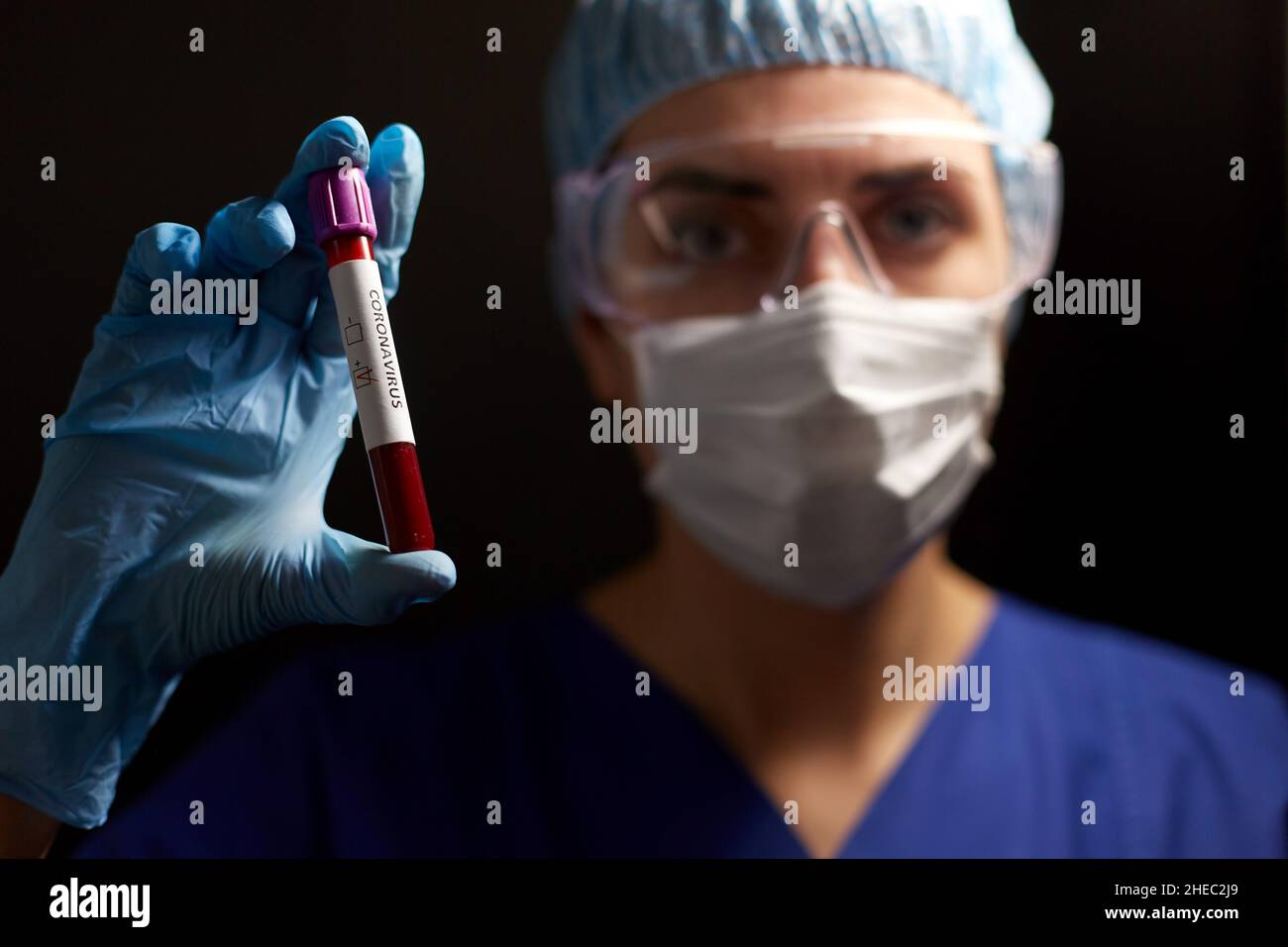 doctor holding beaker with coronavirus blood test Stock Photo - Alamy