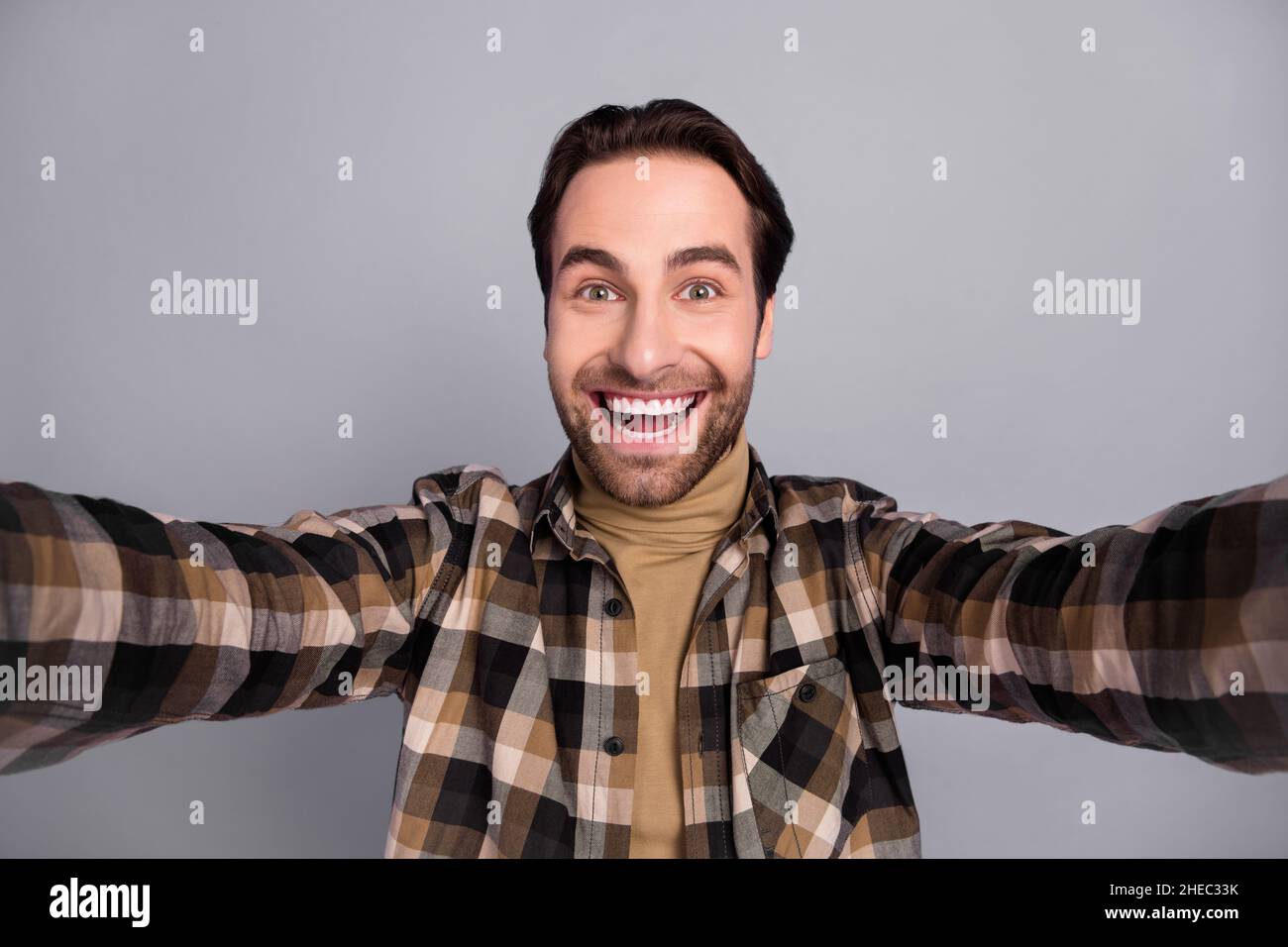 Photo of sweet excited guy dressed checkered shirt tacking selfie ...